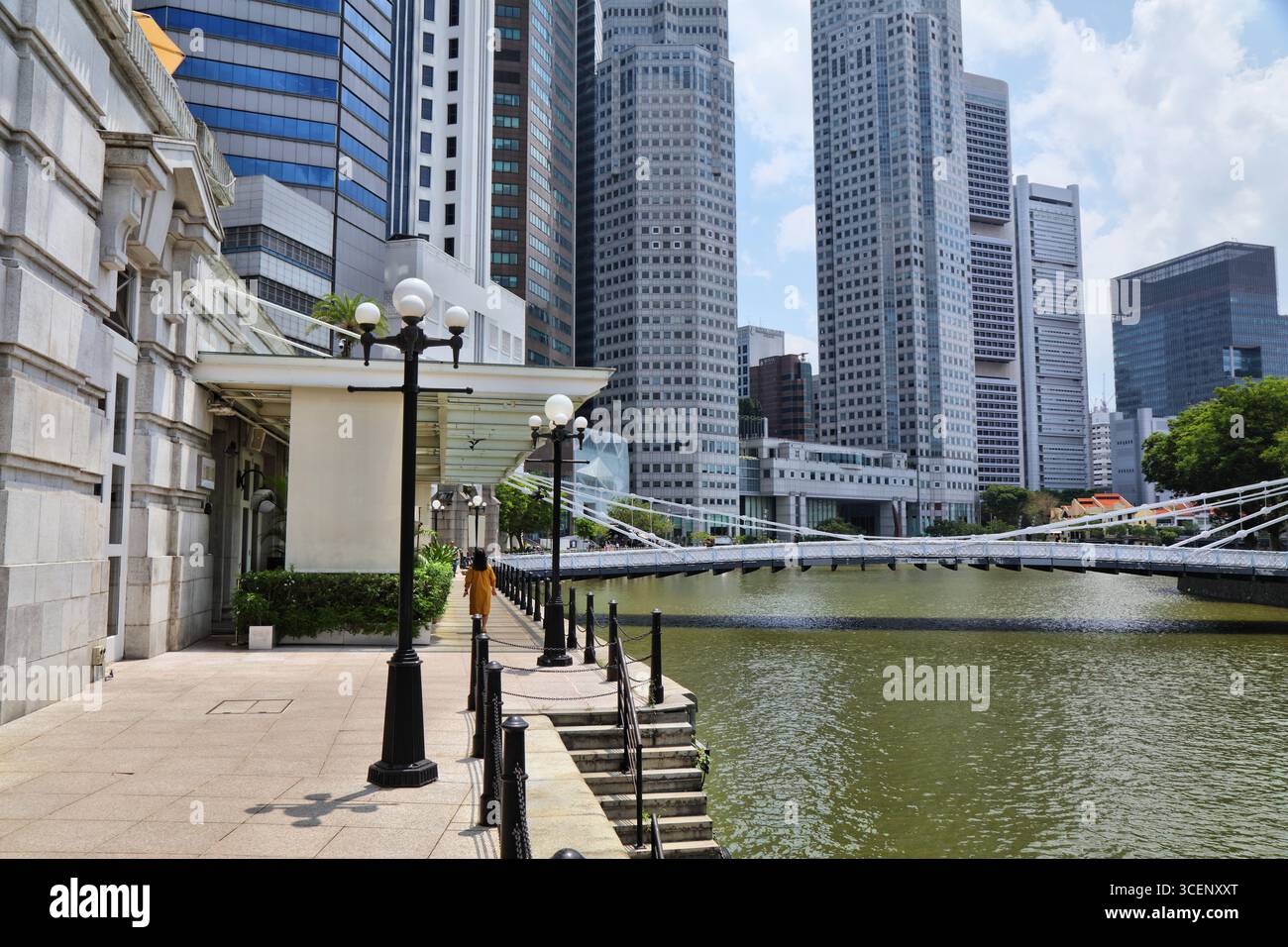 Singapore skyline view from Fullerton Square. Cavenagh Bridge on ...