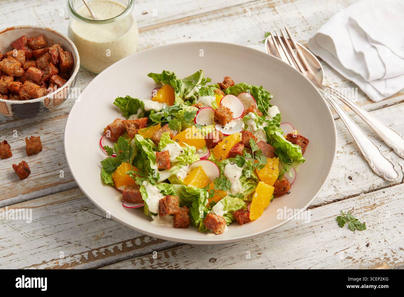 Caesar salad with orange and radishes Stock Photo - Alamy