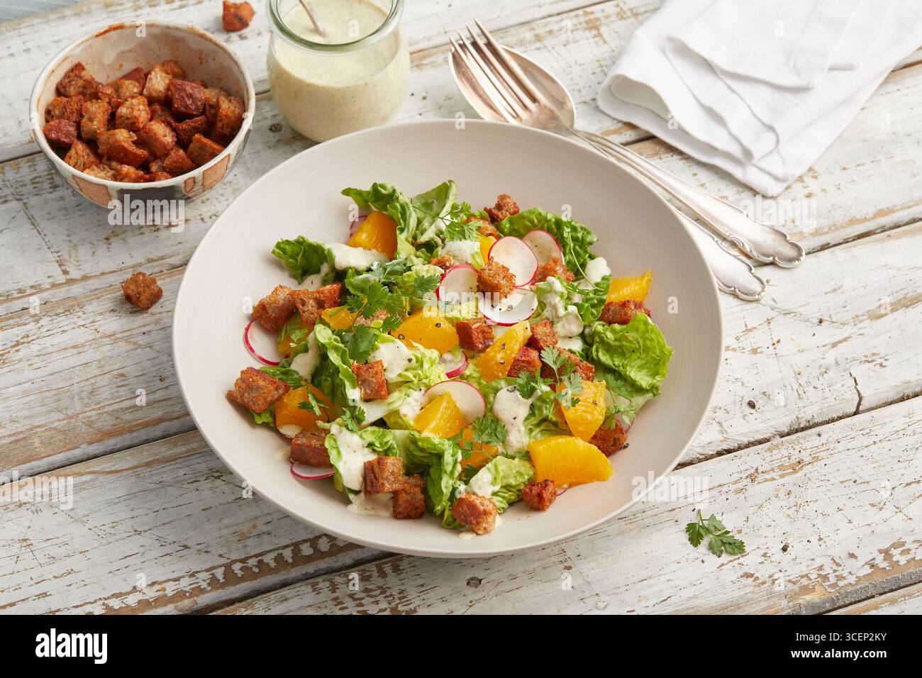 Caesar salad with orange and radishes Stock Photo - Alamy