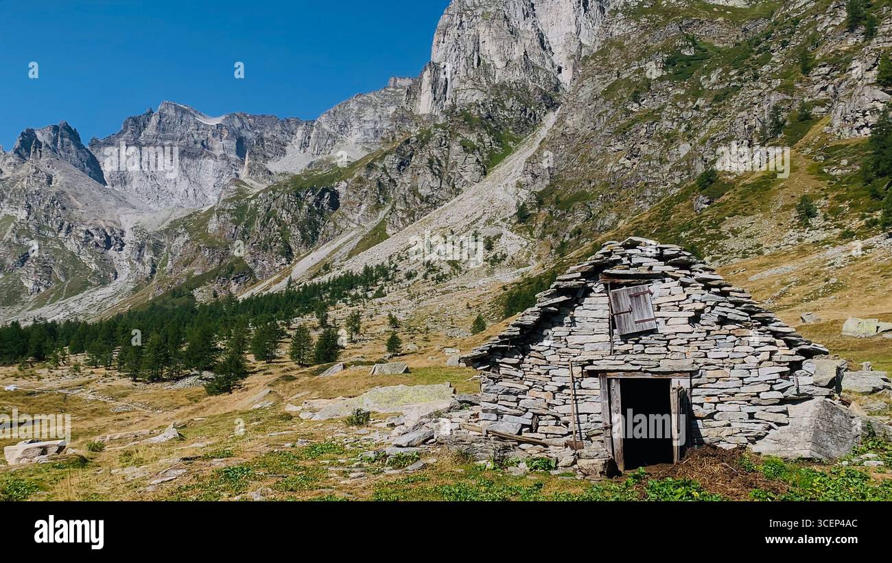 Beautiful mountain landscape with a traditional mountain hut with piode ...