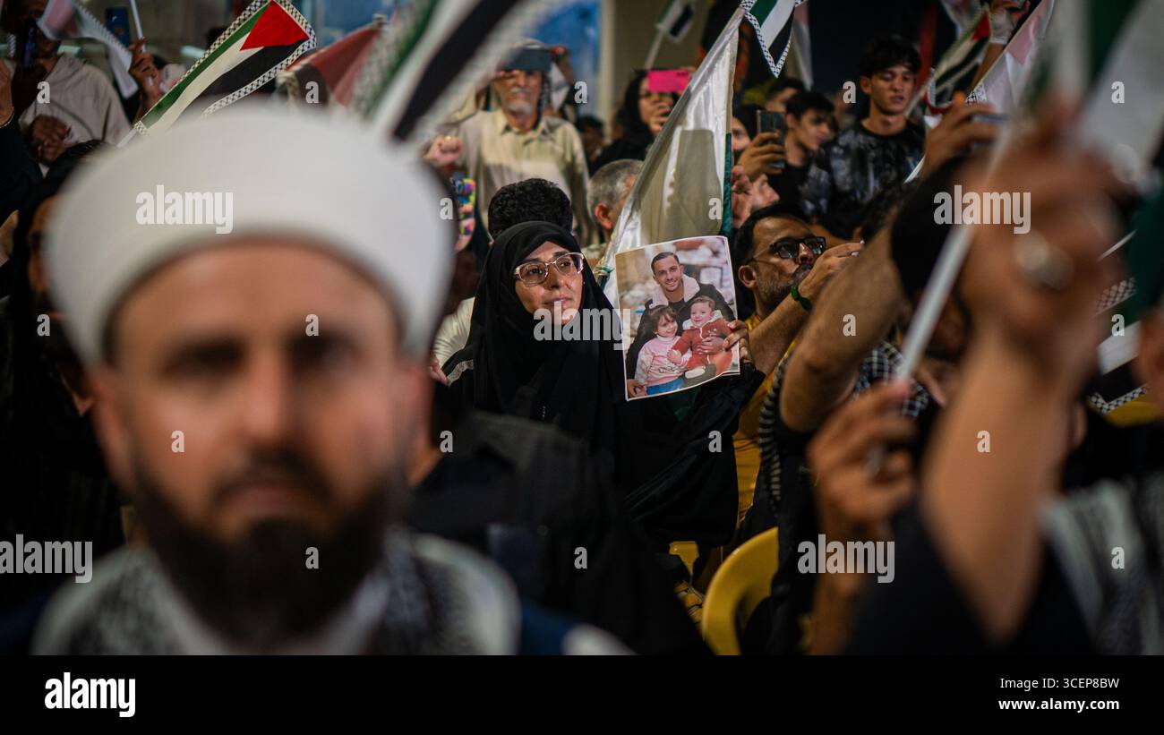 Muslim pilgrims attend Arbaeen 2025 in Karbala, Iraq, holding ...