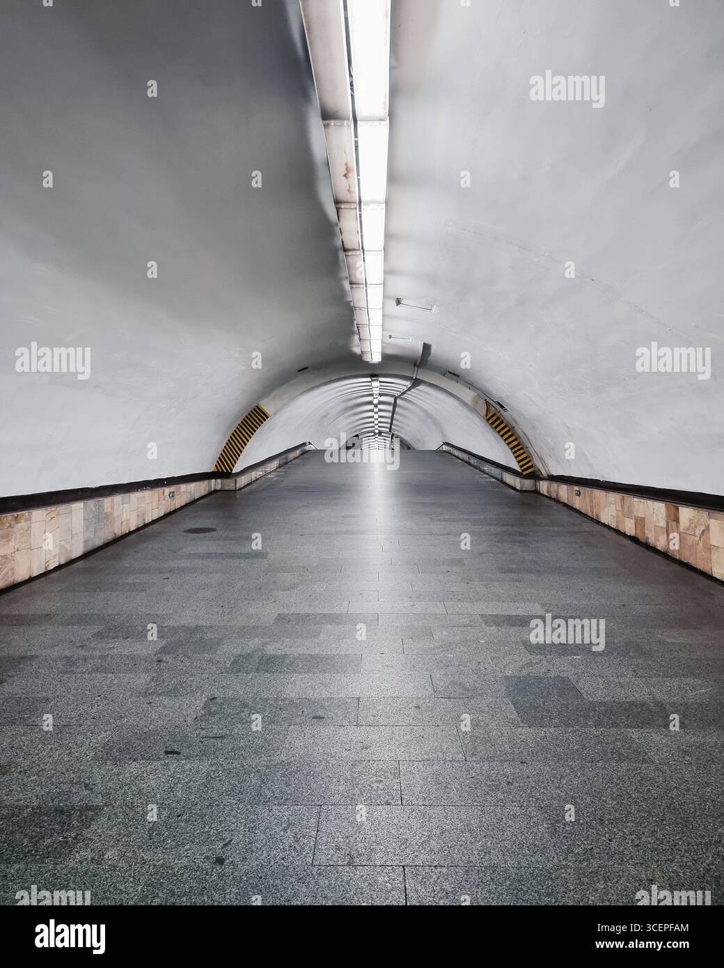 Empty subway walkway tunnel. Perspective view of white half-tube shaped ...