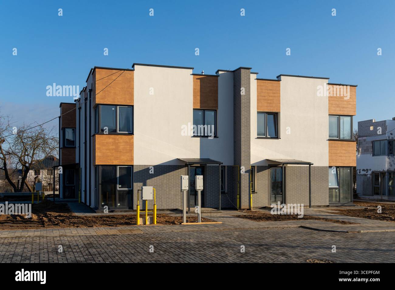 Two-story townhouse at final construction stage. Landscaping the ...