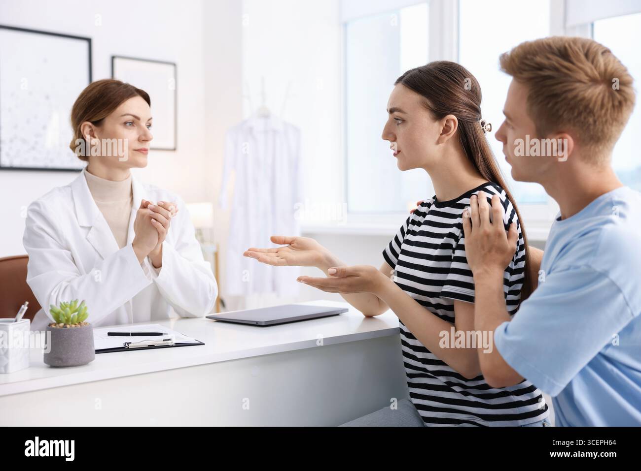 In vitro fertilization (IVF). Couple having appointment with doctor in ...