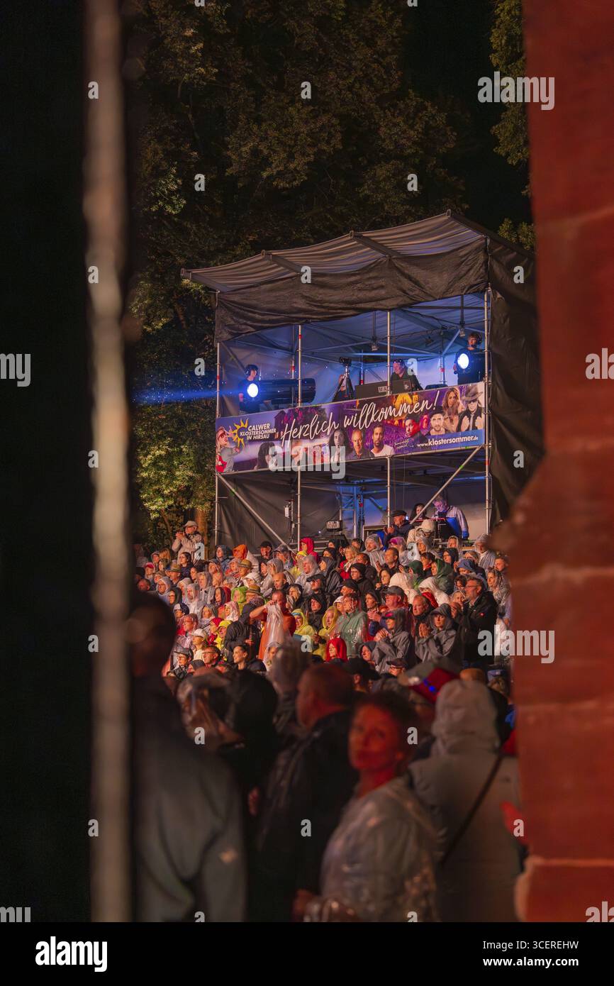 Large crowd in front of an outdoor grandstand illuminated in the dark ...