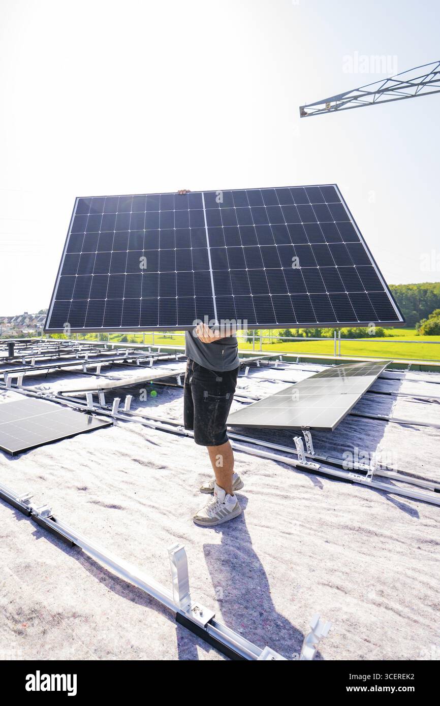 Worker holding solar module hi-res stock photography and images - Alamy