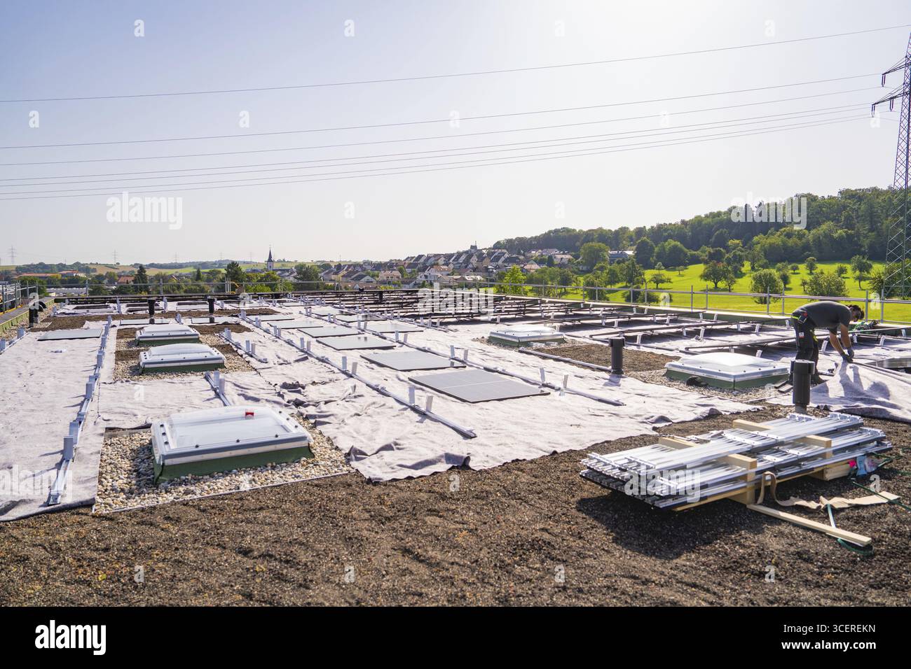 Roof with solar modules and construction equipment with a view of a ...
