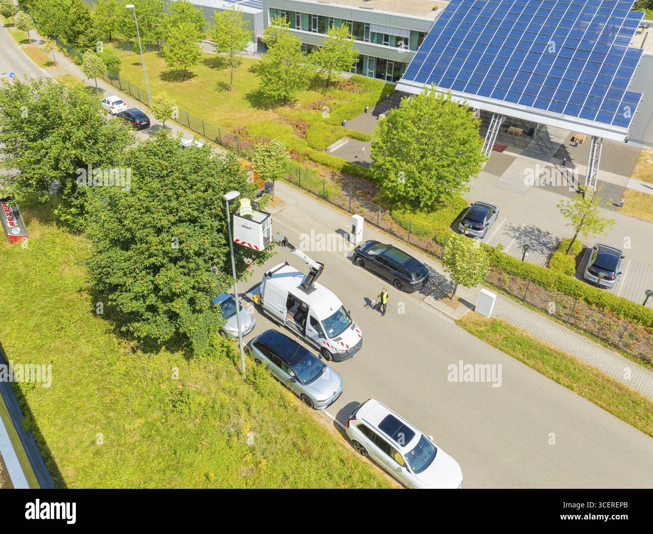 Aerial view of an area with buildings, solar system and cars, lamp ...