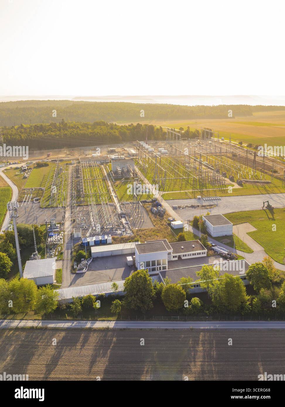 Large transformer station in a wide, natural setting with buildings and ...
