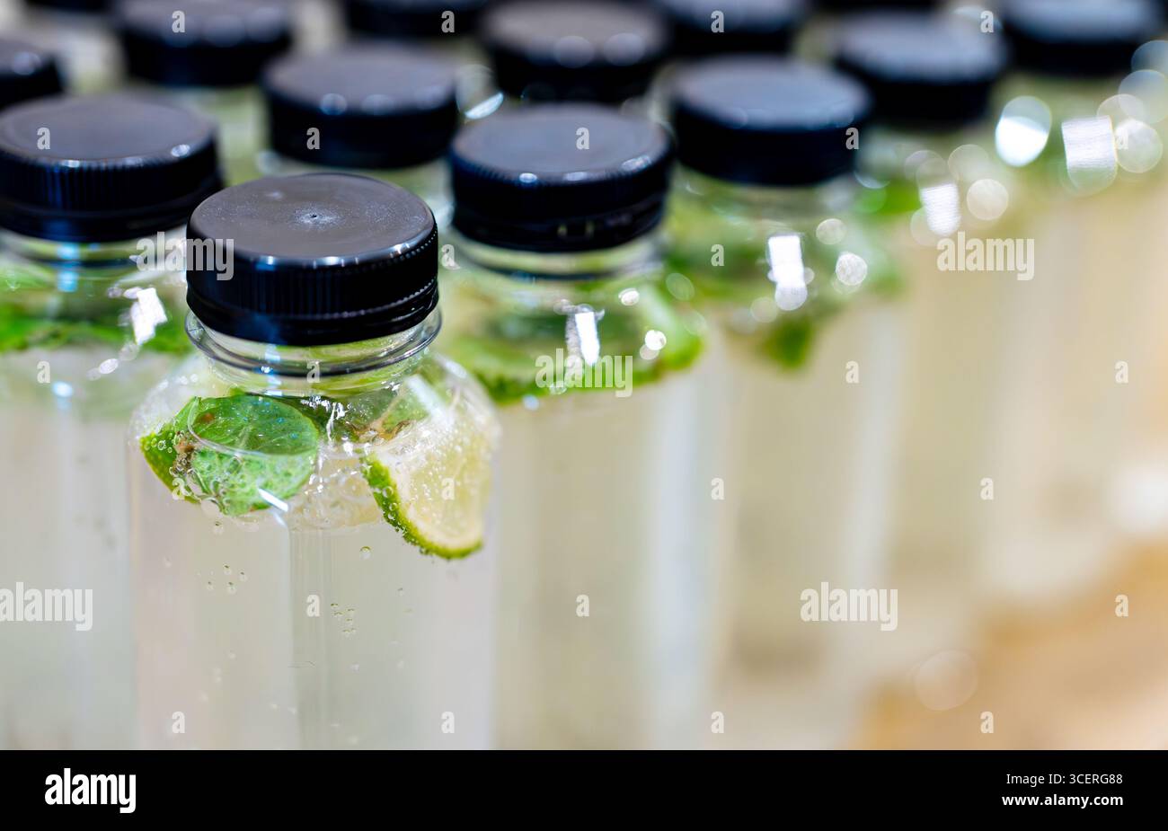 Plastic bottles filled with sparkling lime mint water Stock Photo - Alamy