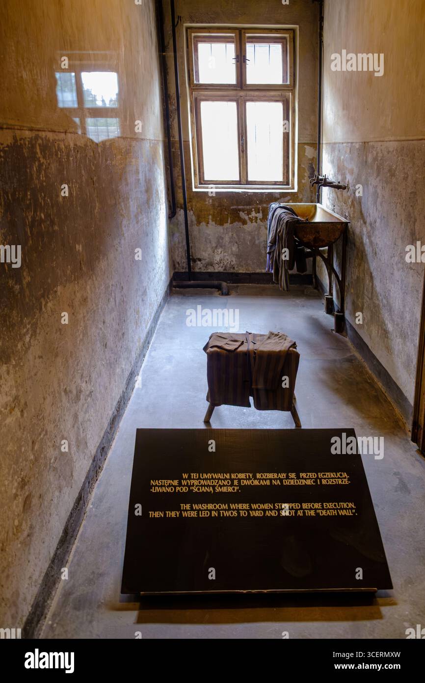 An interior view of a washroom in a barracks at Auschwitz, with a sign ...