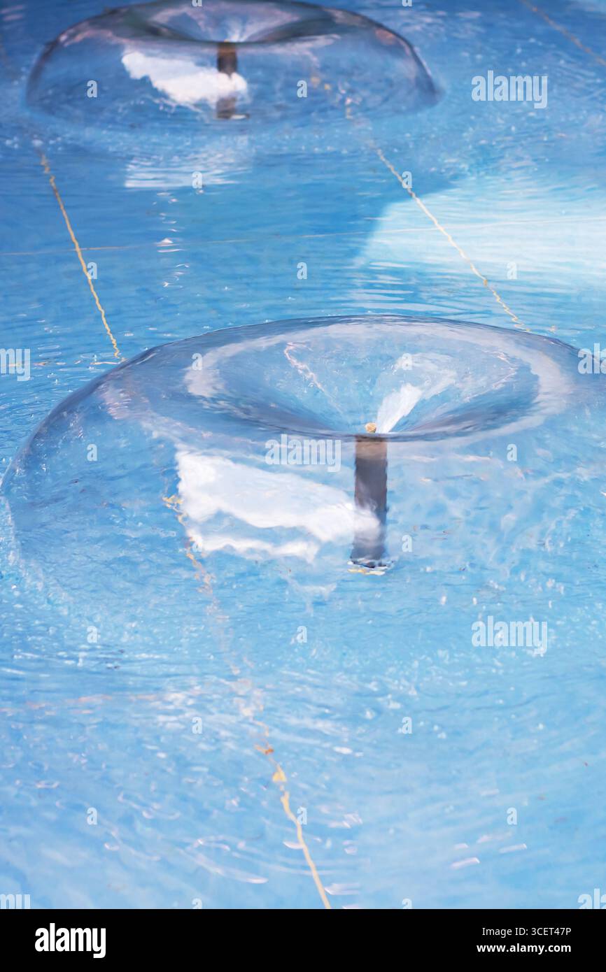 A serene scene featuring floating bubble-like structures on a calm blue ...