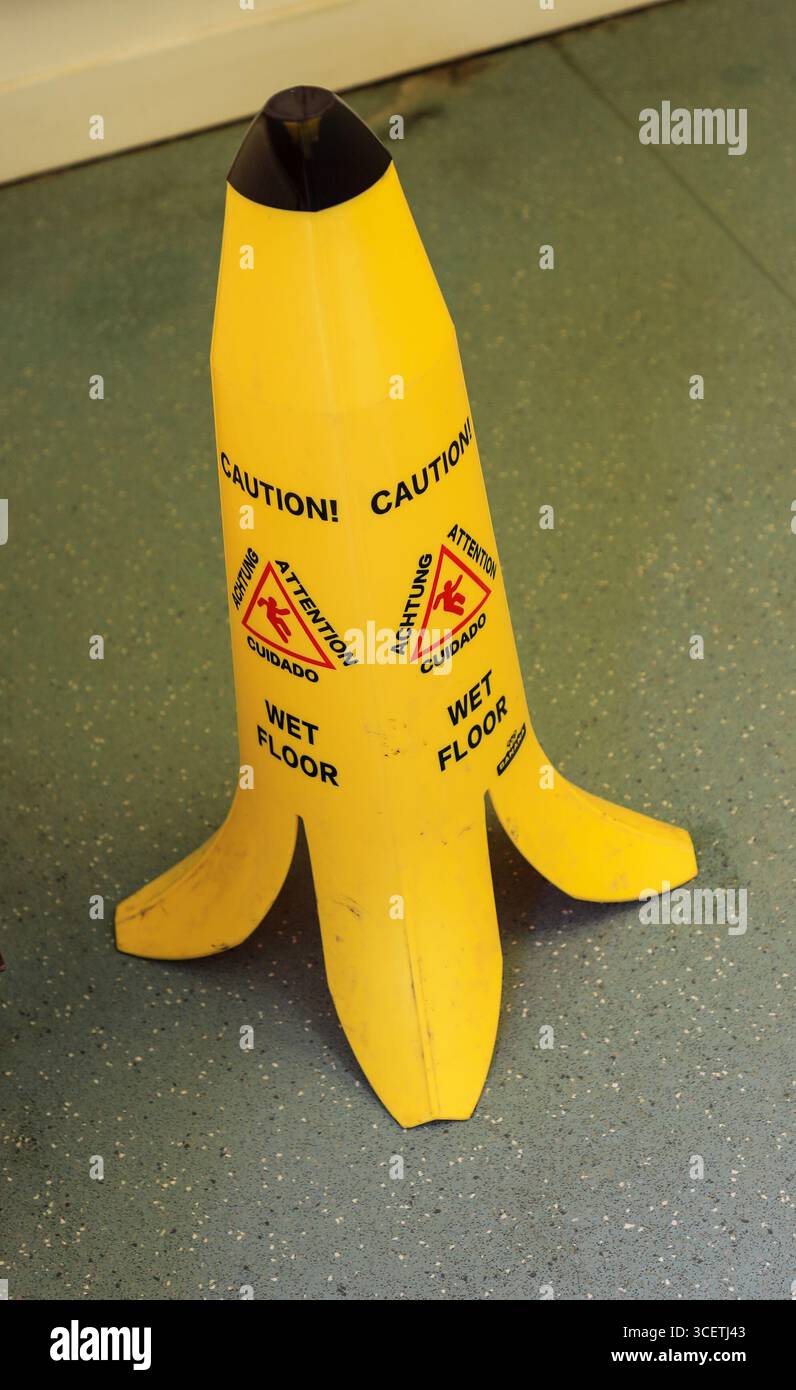 A warning cone in use for cleaning floors in the shape and colour of a ...