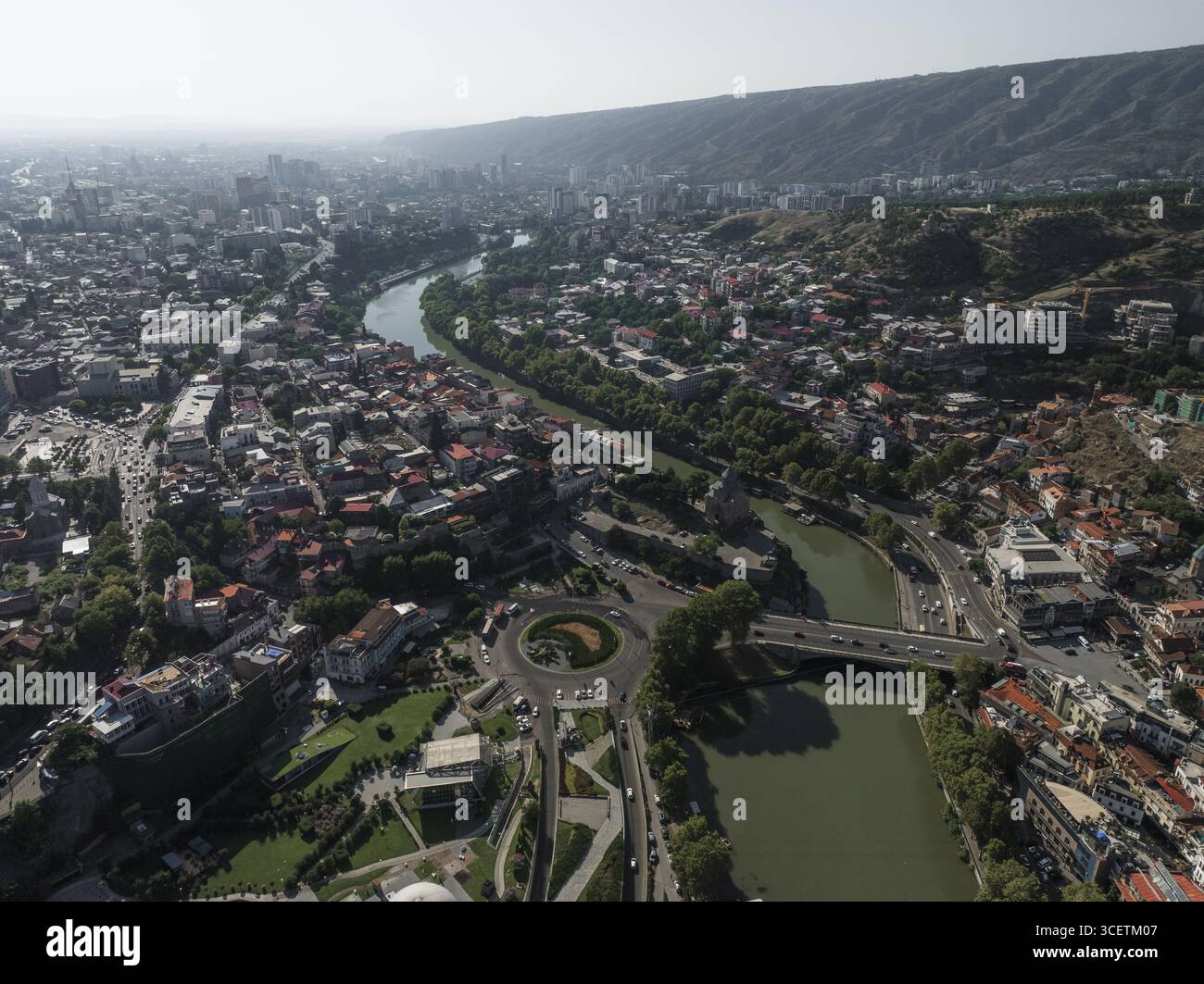 Aerial view of the Mtkvari River flowing through the city with bridges ...