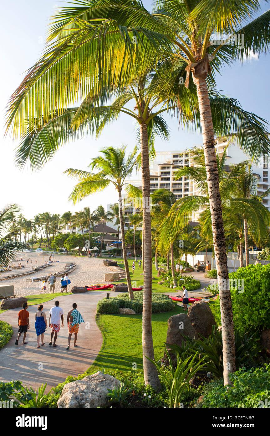 People walking on path along beach fronting the Aulani, A Disney Resort ...