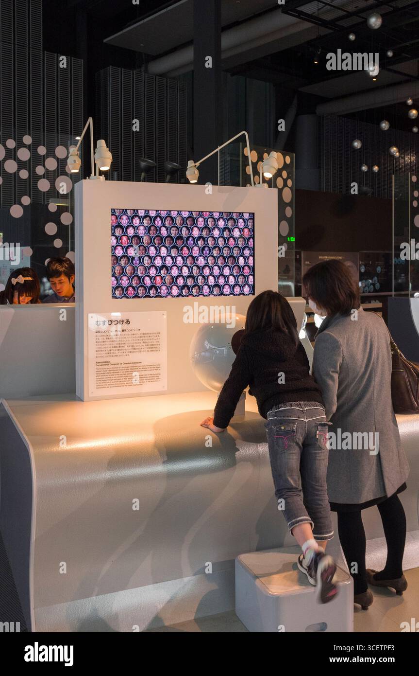 Japanese mother and daughter interacting with the “Association” exhibit ...