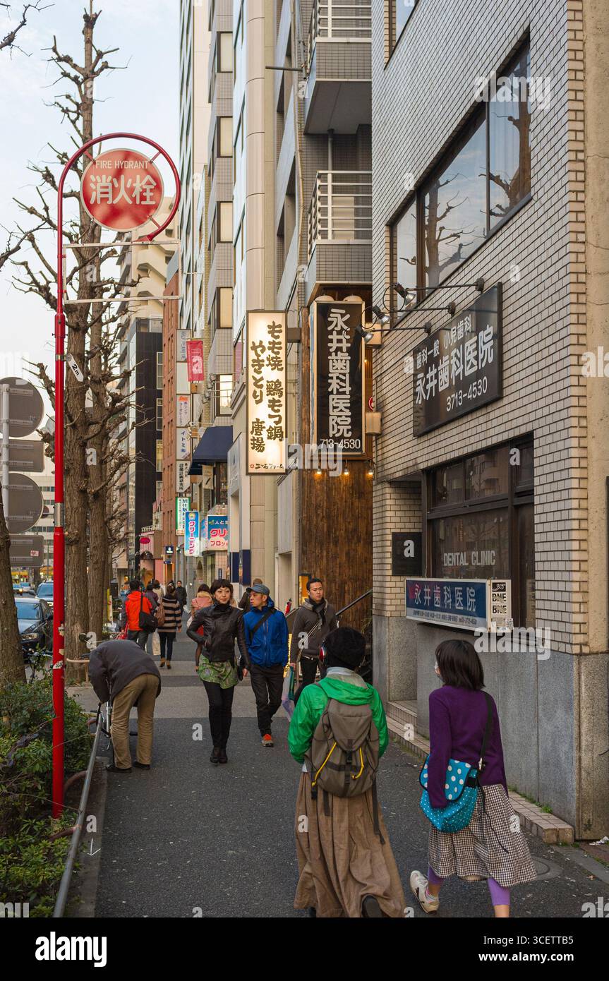 Japanese people walking on sidewalk along Komazawa-dori, Ebisunishi ...