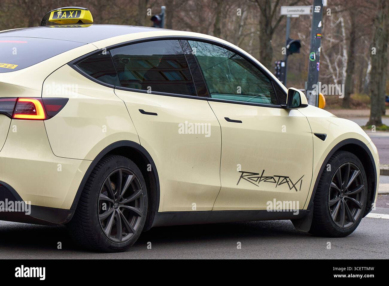 Bavaria, Germany August 19, 2025: PHOTOMONTAGE STICKER, A Tesla with a ...