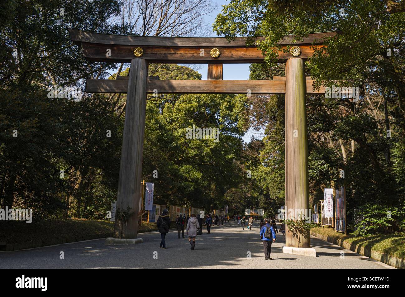 Visitors passing through the Torii shrine archway on the grounds of the ...