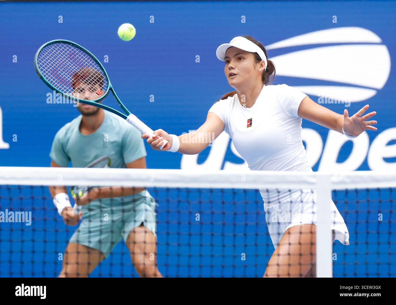 Carlos Alcaraz of Spain watches Emma Raducanu of Great Britain hit a ...