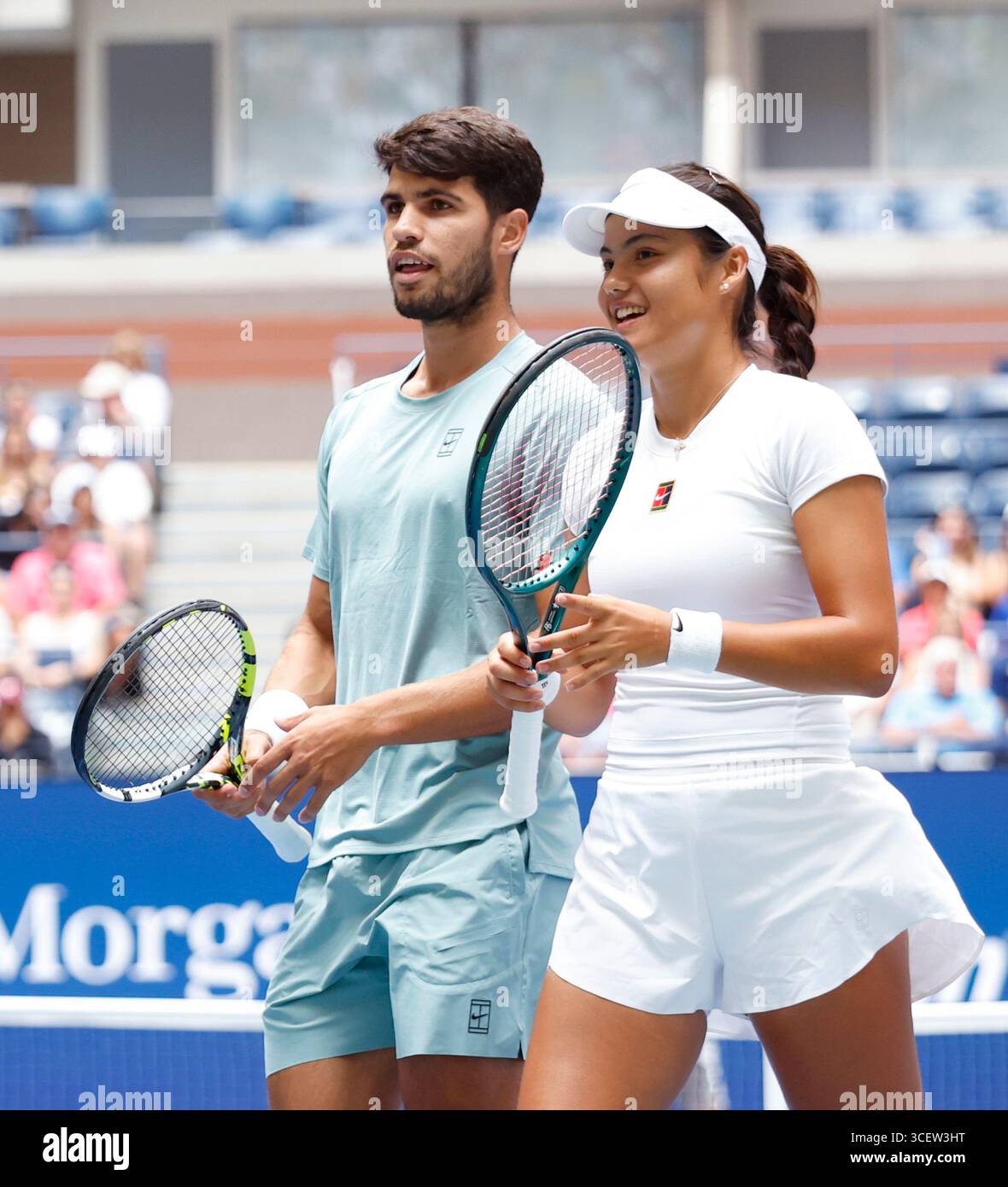 Emma Raducanu of Great Britain and Carlos Alcaraz of Spain walk back to ...