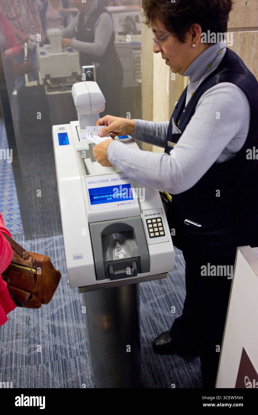 Woman scanning boarding passes hi-res stock photography and images - Alamy