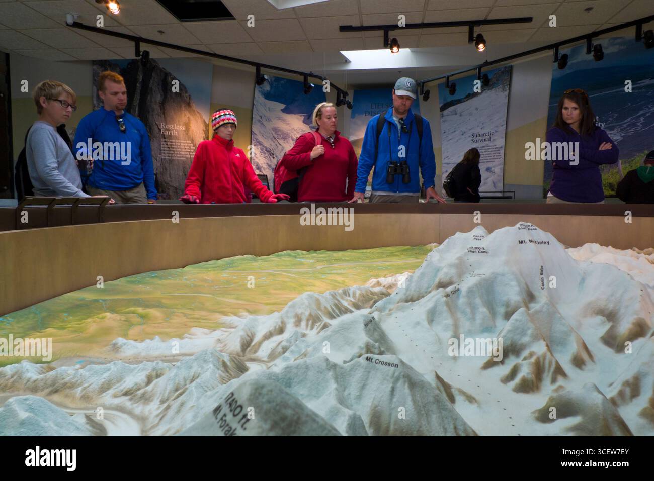 People looking at a scale model of Mt. McKinley inside Eielson Visitor ...