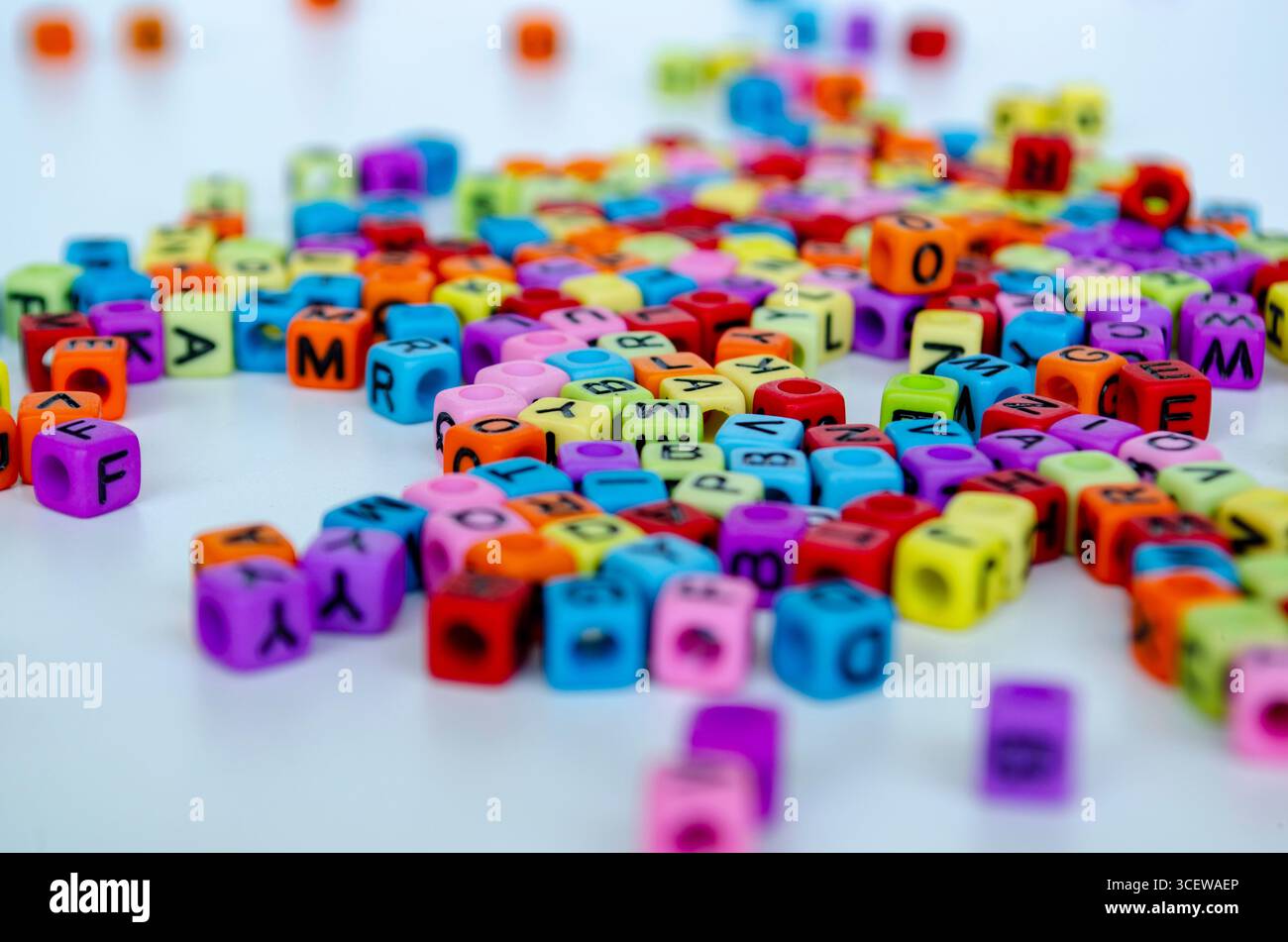 A clustered pile of lively colored alphabet cubes stacked together ...