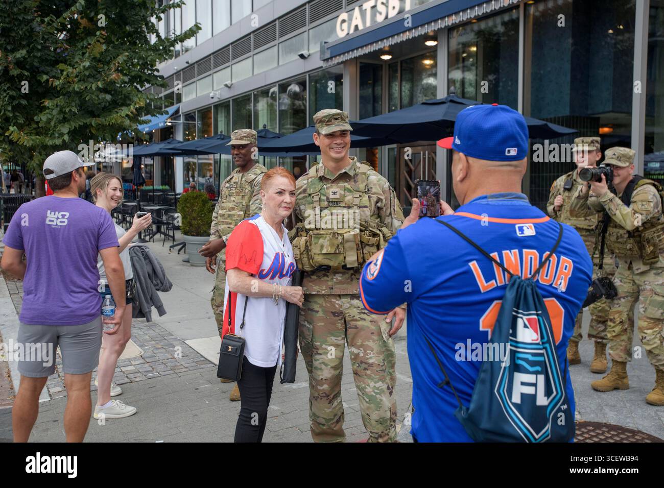 Jose Valentin, right, takes a photo of Nancy Plaza and a member of the ...