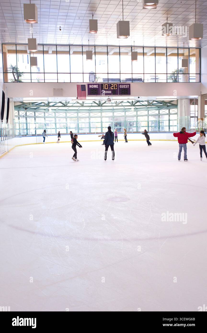 Adults and children ice skating in indoor ice rink, Promenade on the ...