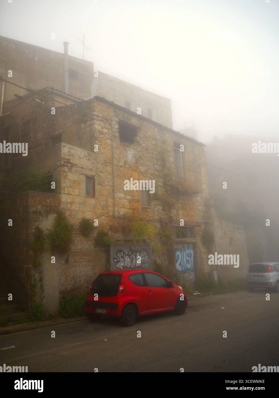 Abandoned stone house in morning fog with graffiti walls and a striking ...