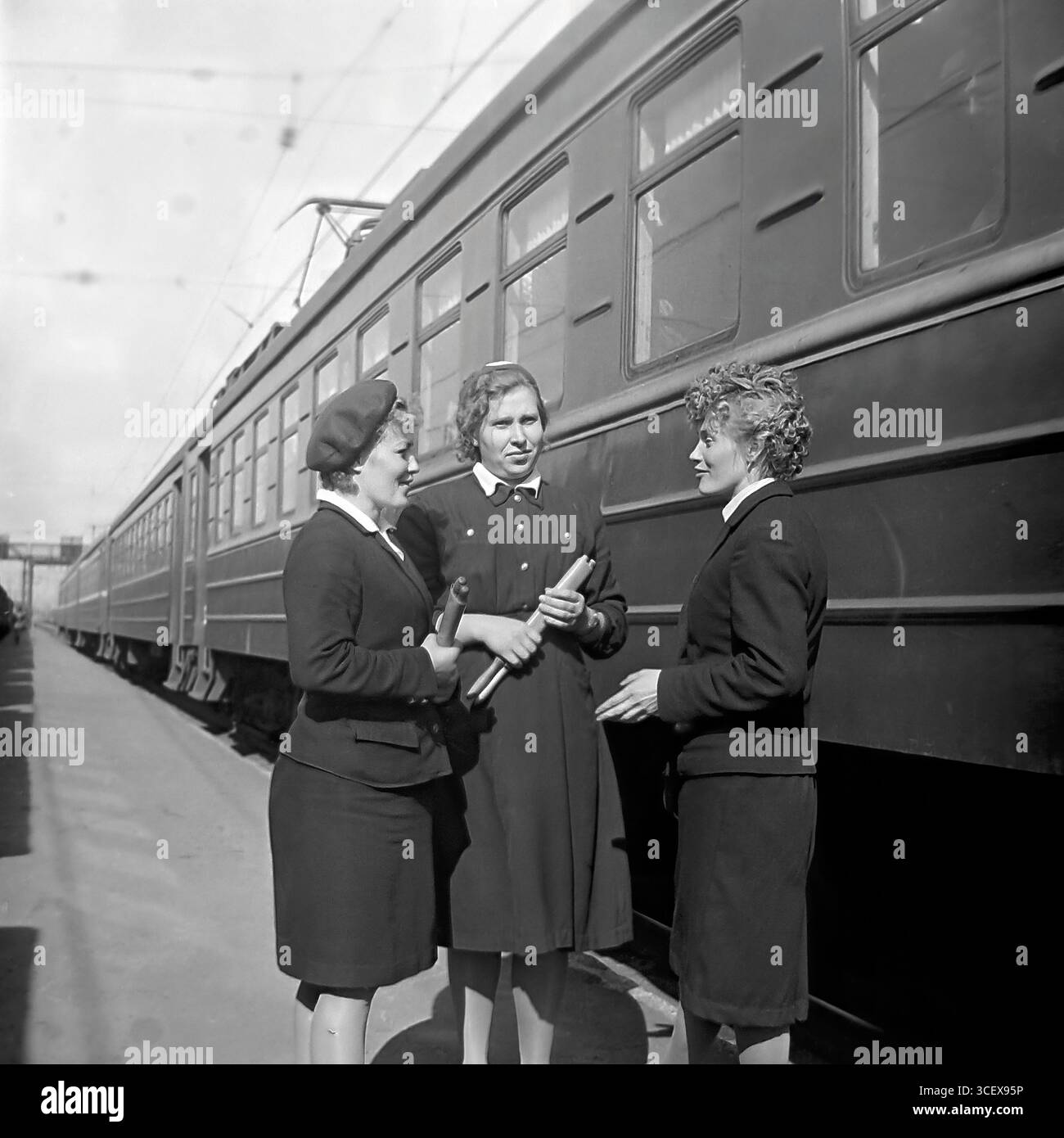 Donetsk Railway female employees in uniform chat on the platform next ...