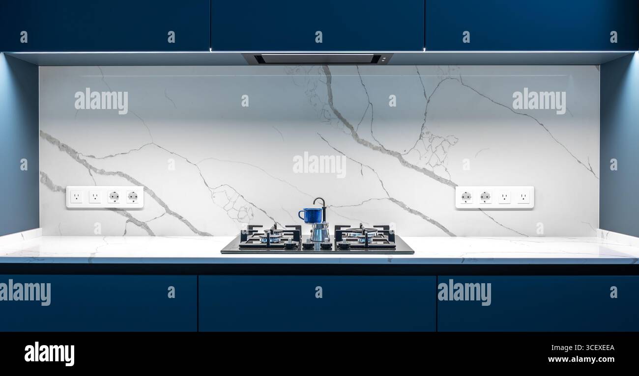 Modern kitchen. Marble backsplash. Blue kitchen cabinets Stock Photo ...