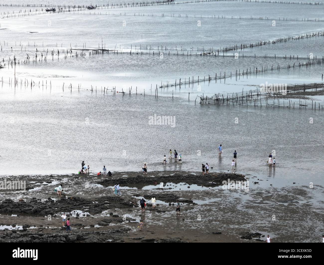 People go beachcombing in Fangchenggang City, south China's Guangxi ...
