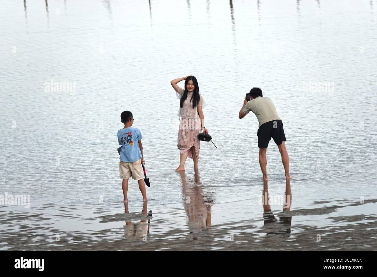 People go beachcombing in Fangchenggang City, south China's Guangxi ...