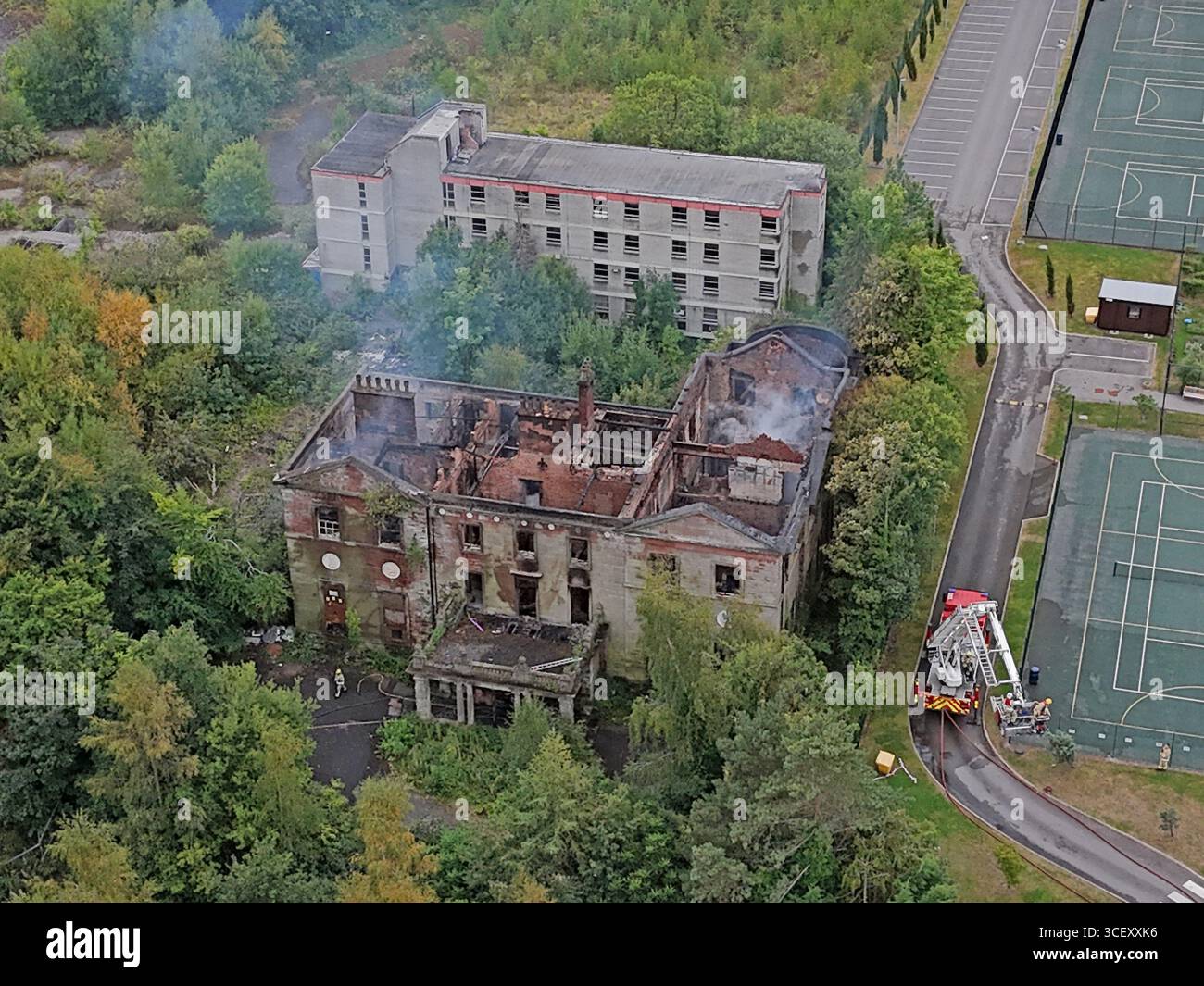 Fire crews continue to work at the scene of Woolton Hall in Liverpool ...