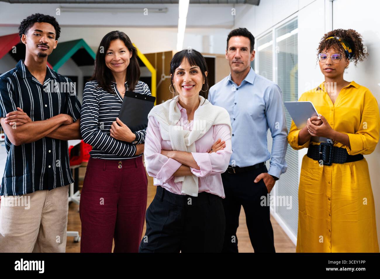 Multi-ethnic group of professionals standing together in contemporary ...
