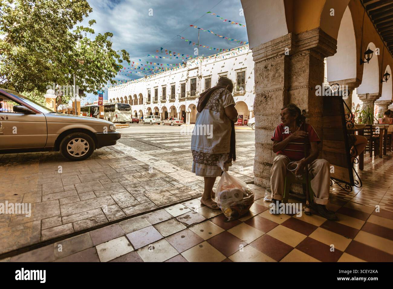 Valladolid, mexico 20 august 2025: local woman sharing food with a ...