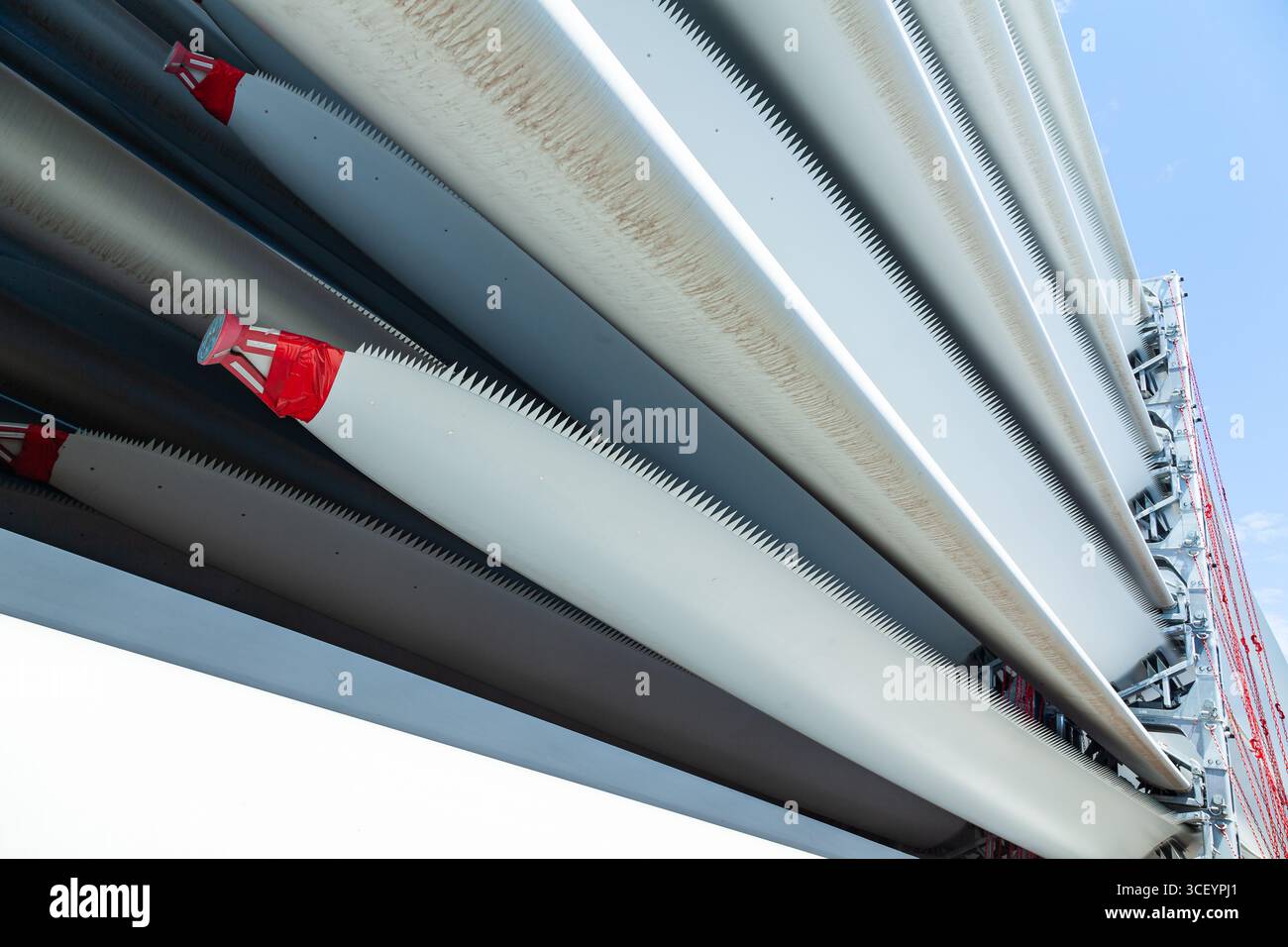 Blades from wind turbines laid in special fasteners and chained on the ...