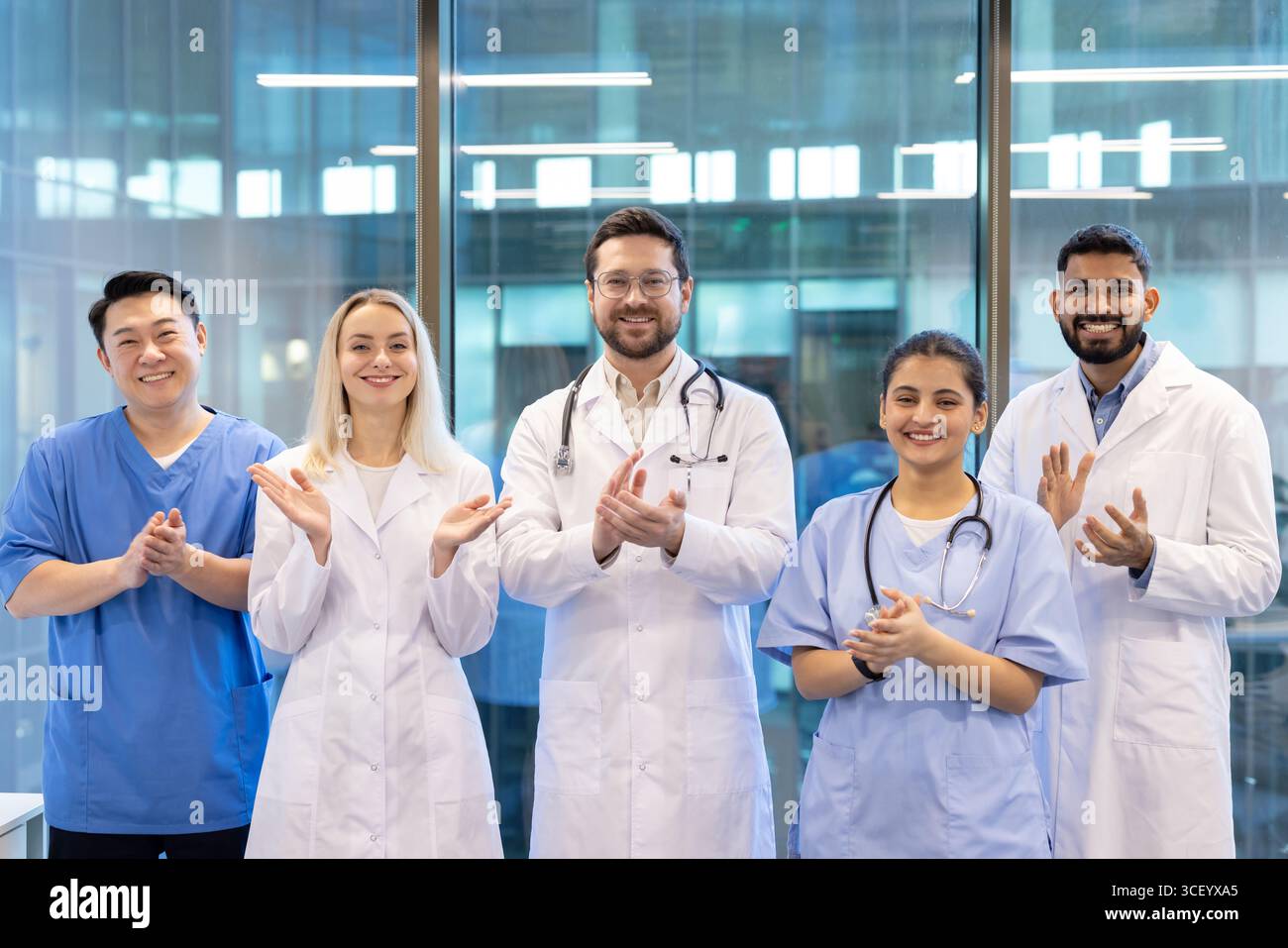 Healthcare professionals, including doctors and nurses, applauding ...