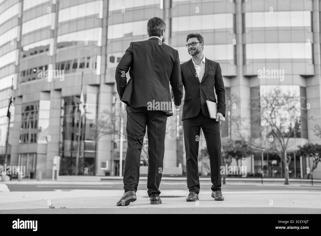 Handshaking partner Black and White Stock Photos & Images - Alamy