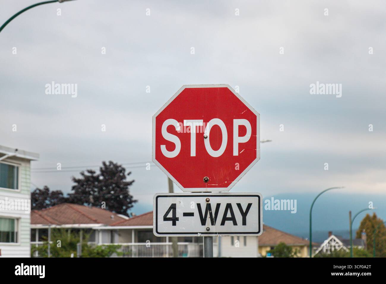 Close-up of a red stop sign with a 4-way indicator at a suburban ...