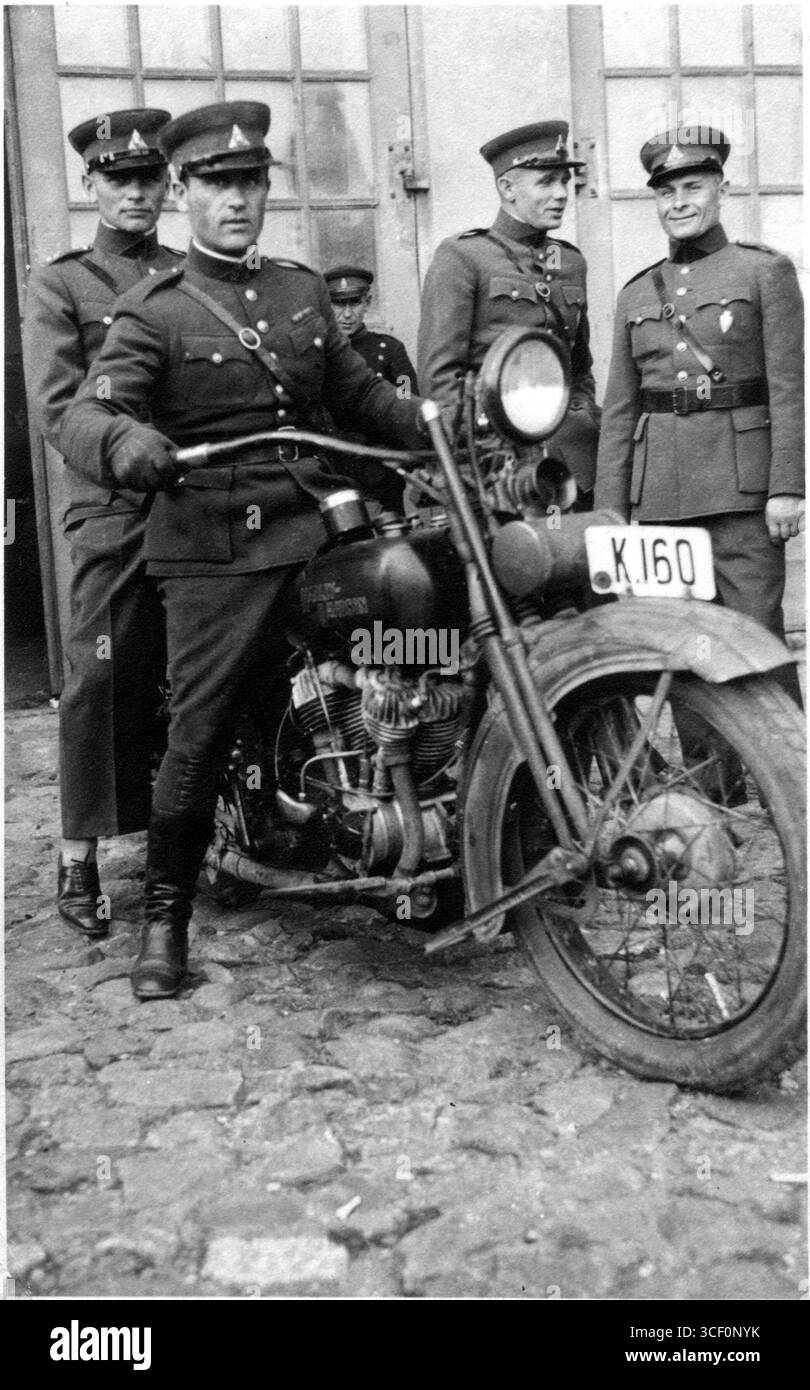 Four Lithuanian riflemen in uniform, accompanied by a policeman, with ...