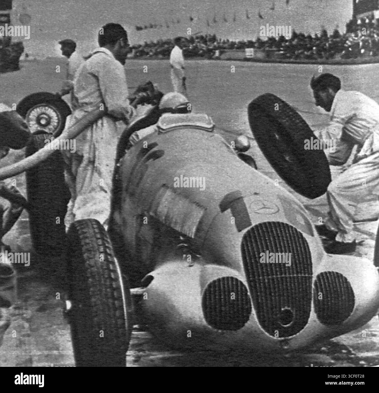 Hermann Lang, a German racing driver, is seen in the pit during the ...