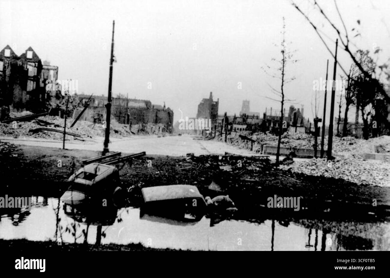 This image shows a car in the water at Westersingel with remnants of ...