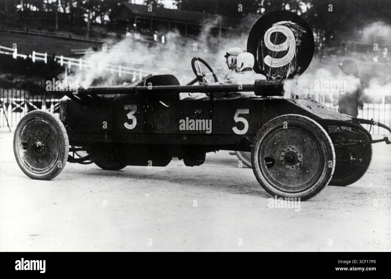 A historical two-person race car is shown on the Brooklands racetrack ...