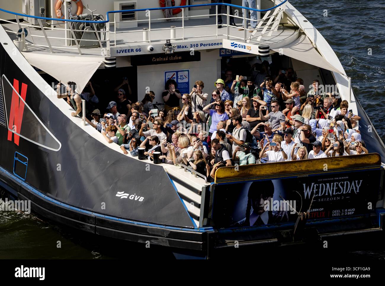 AMSTERDAM – A crowded ferry tries to navigate through many boats and ...