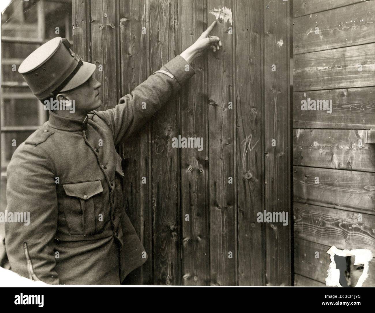 A soldier points to a bullet hole in a barrack wall in Assen ...