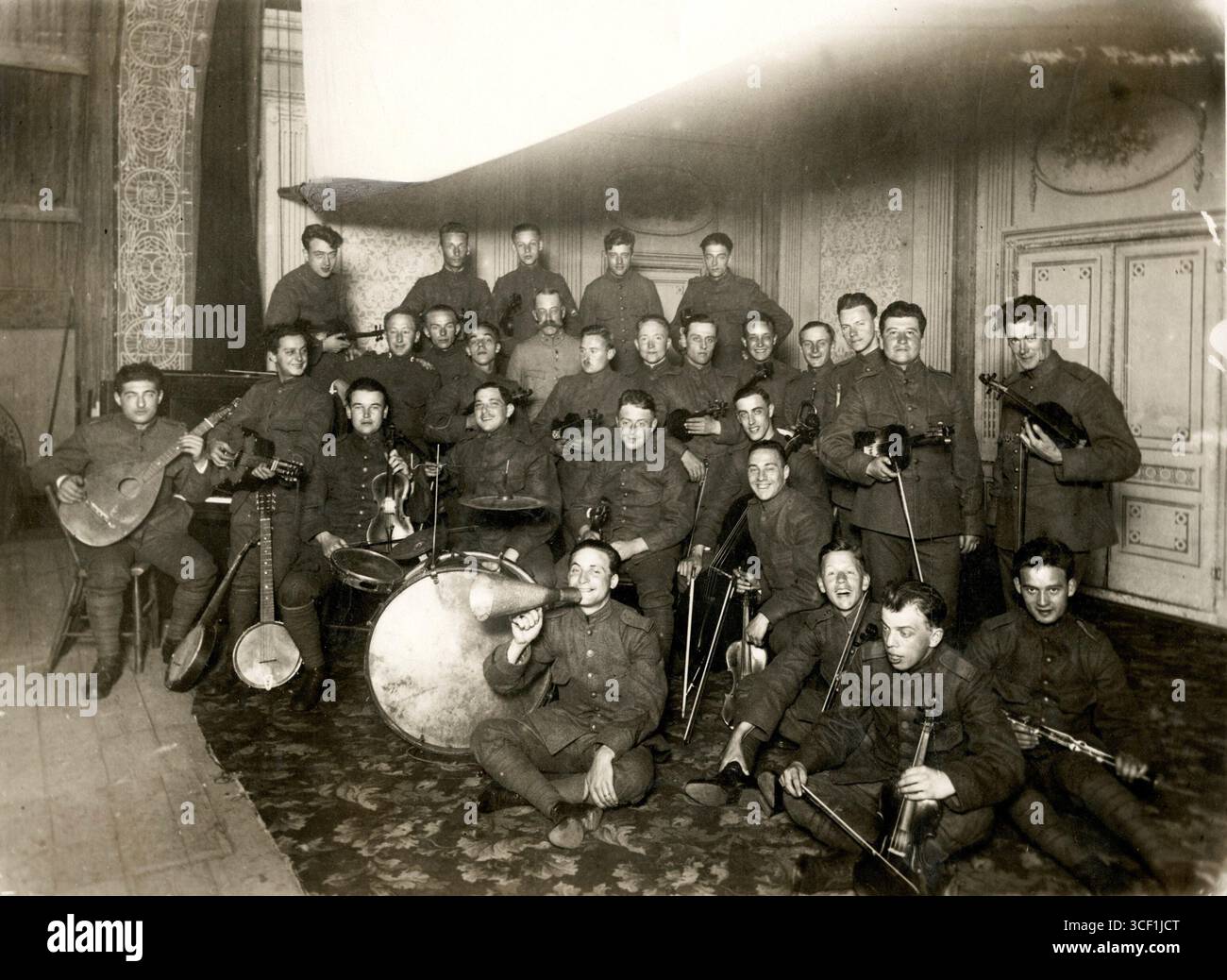 A group of Dutch soldiers in uniform playing various musical ...