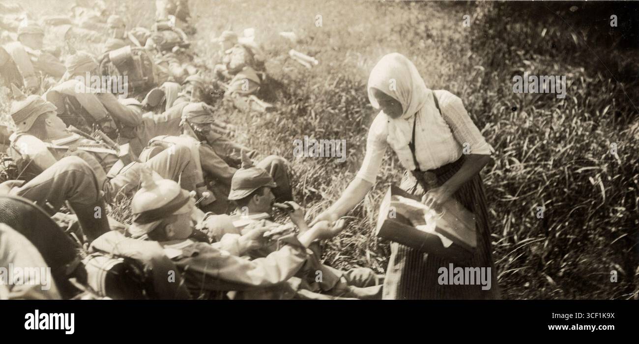 An East Prussian farmer distributes bread to German soldiers at the ...